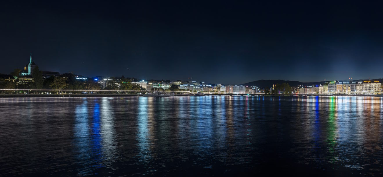 On the top of the World... illuminated rooftop signs on the Lake Geneva ...